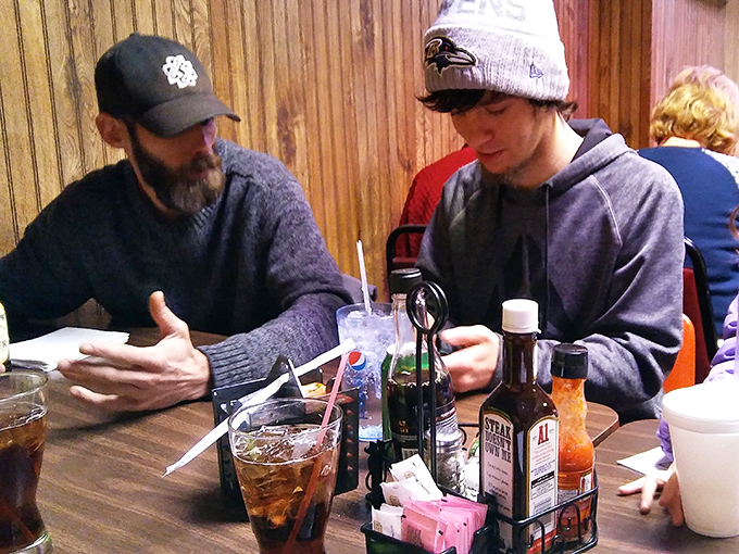 Real conversations happen here, not the kind punctuated by phone notifications. Old-school human connection with a side of fries.