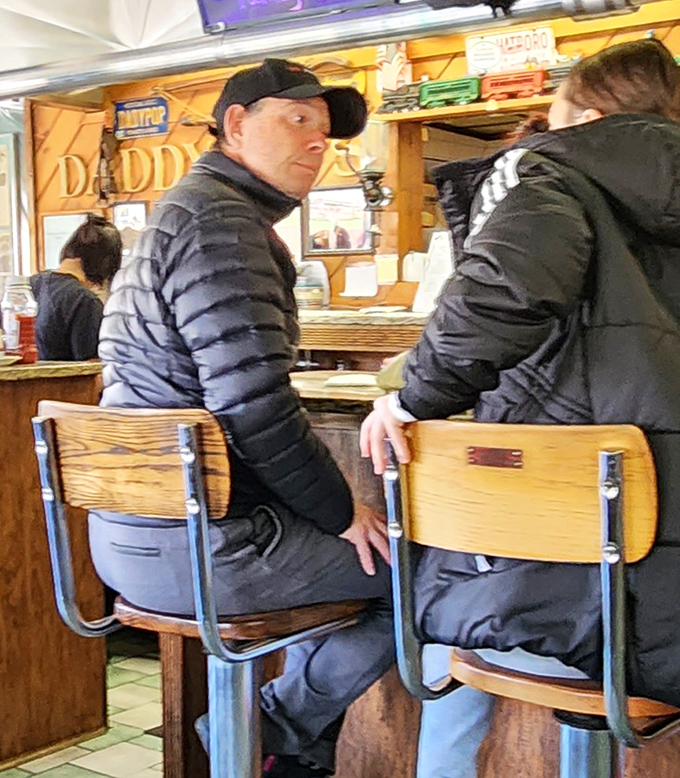 Counter seating where strangers become friends over coffee and the universal language of comfort food.