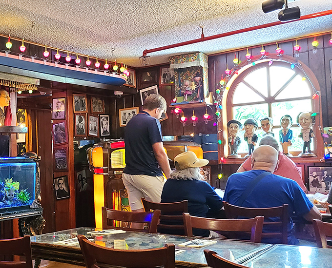 Diners settle in beneath walls of memories, where every photograph and poster adds to the visual feast.