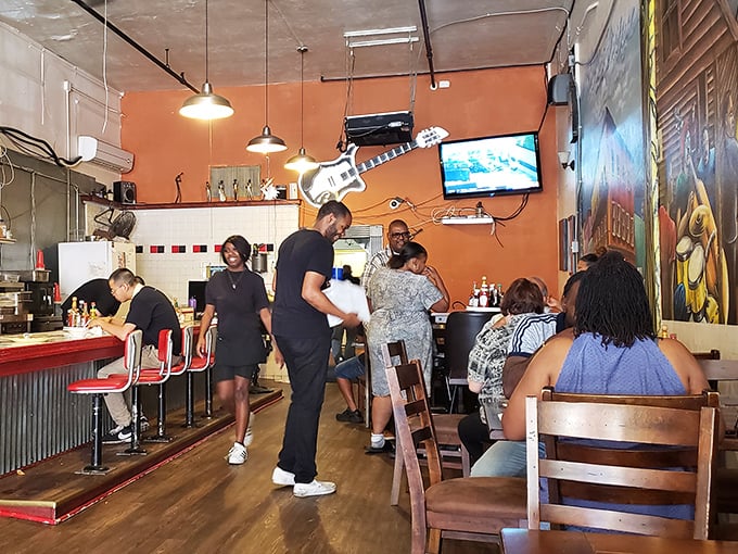 Where strangers become friends over shared food experiences. That guitar hanging from the ceiling? Just another conversation starter in a room full of them.