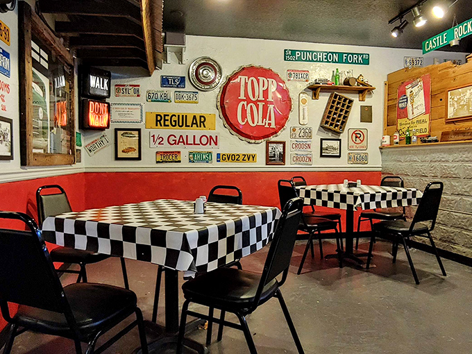 The dining area's red accents and checkered tablecloths pop against vintage automotive memorabilia&mdash;eating here is time travel with toast.