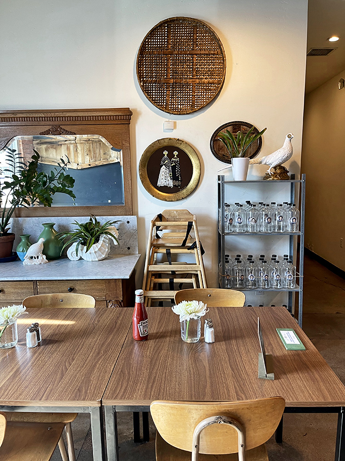 Thoughtful interior touches like vintage mirrors and plants create a space where you want to linger long after your plate is clean.