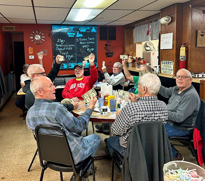 When the regulars raise their hands like this, they're either voting on the day's hot topic or celebrating another perfect breakfast. Democracy in action.