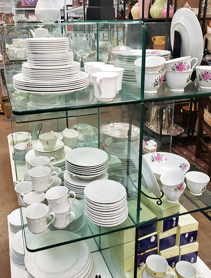 Fine china and delicate teacups await their next dinner party or afternoon tea, stacked with care and priced with kindness.
