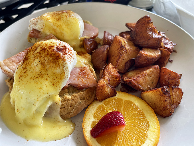Eggs Benedict executed with precision. That hollandaise sauce cascades like a yellow waterfall of buttery goodness over Canadian bacon.