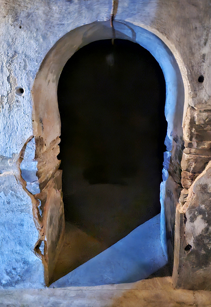 The arched entrance to the underground cells beckons visitors into darkness, promising stories that won't make your vacation slideshow.