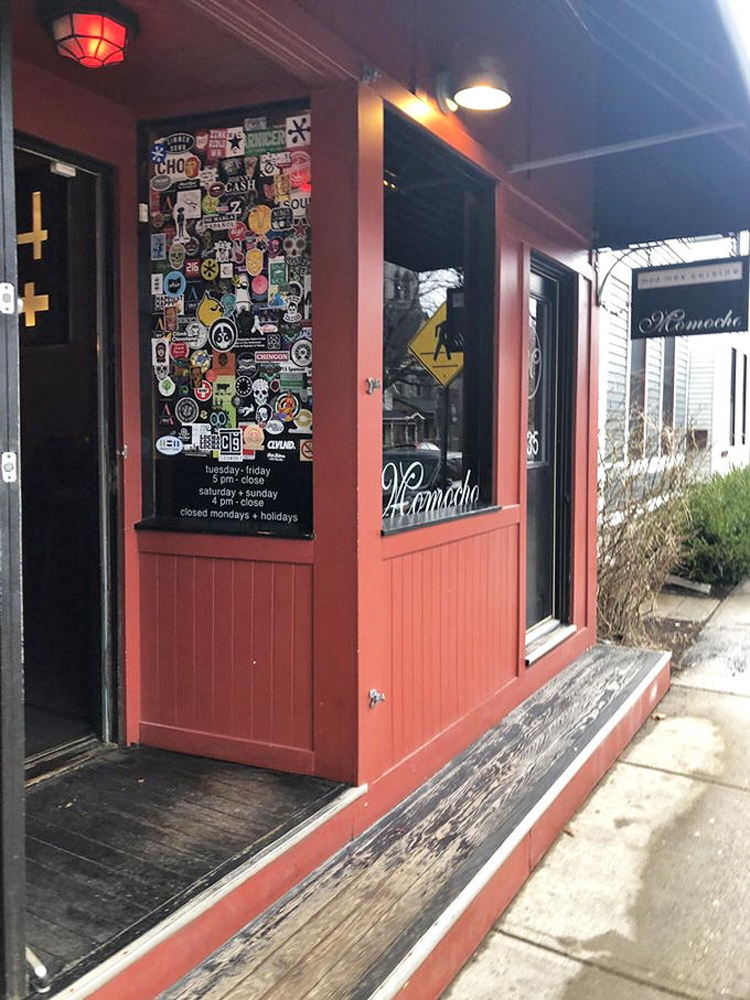 The entrance door plastered with stickers and emblems serves as a colorful manifesto of Momocho's punk rock approach to traditional Mexican cuisine.