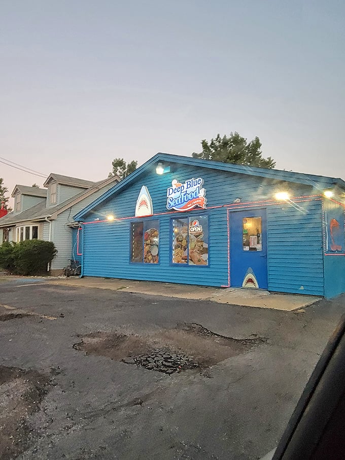 As dusk falls, the blue building glows like a beacon of seafood salvation. Even the sharks look friendly when they're illuminated against the twilight sky.