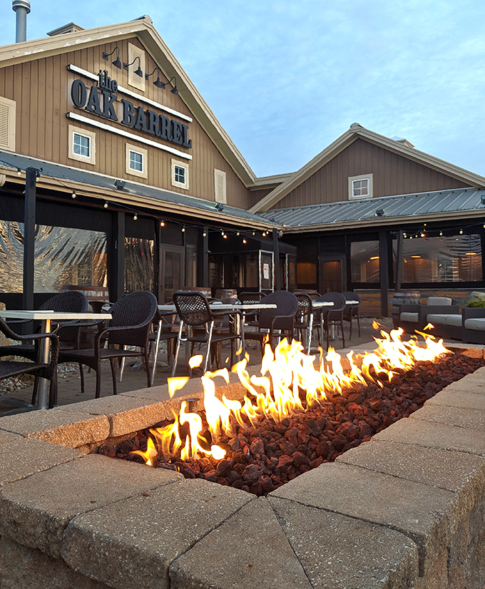 Fire dancing in its stone enclosure, promising warmth and ambiance for diners who appreciate that good food tastes even better with a view.