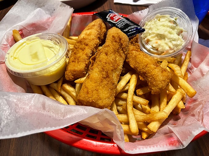 Fish and chips that would make the British jealous, golden-battered treasures nestled in a sea of perfectly crisp fries.