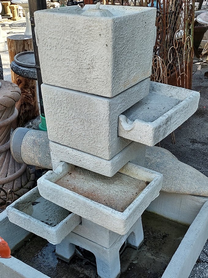This fountain piece waits patiently for a new garden to call home, ready to become someone's backyard centerpiece.