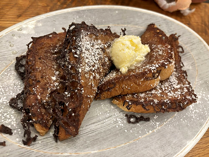 French toast that's clearly been working out&mdash;thick-cut, caramelized edges, and a dollop of butter slowly surrendering to the warmth.