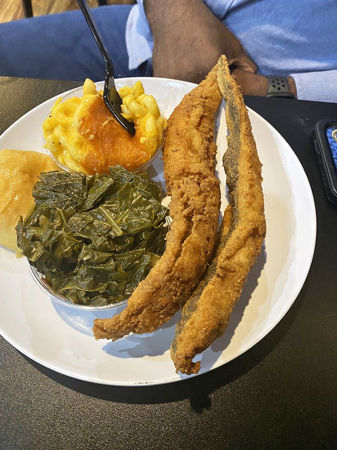 A Southern trinity: perfectly fried fish, mac and cheese that could solve world peace, and collard greens cooked with respect and tradition.
