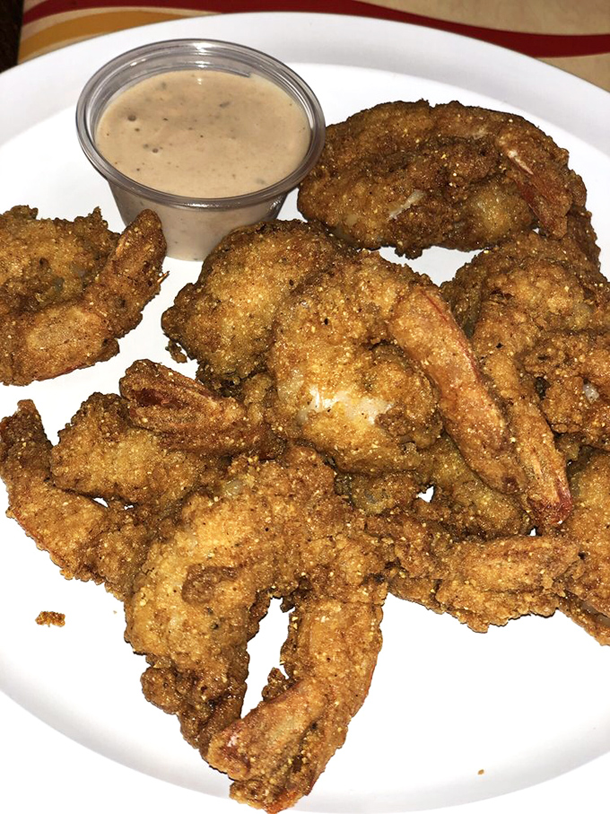 Fried shrimp with a crust so perfect it should win architectural awards. That dipping sauce isn't optional&mdash;it's the final brushstroke on a masterpiece.