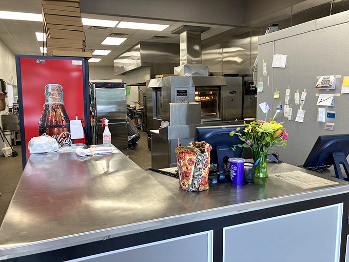 Behind the scenes where pizza magic happens &ndash; stainless steel, precision, and the kind of organized chaos that produces perfection.