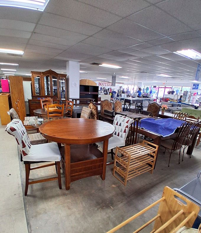 Furniture arranged like a living room Tetris game, each piece waiting for someone to recognize its potential beyond the scratches and worn spots.