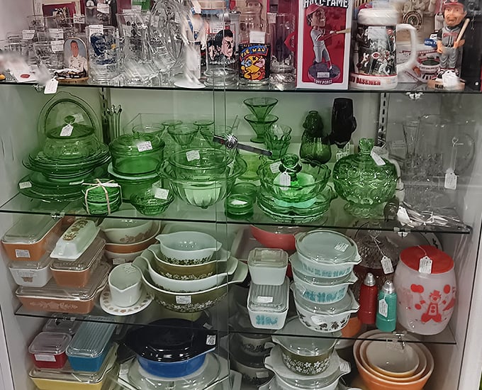 Depression glass and vintage Pyrex create a green symphony of collectible kitchenware. Grandmother's cabinet never looked this organized.