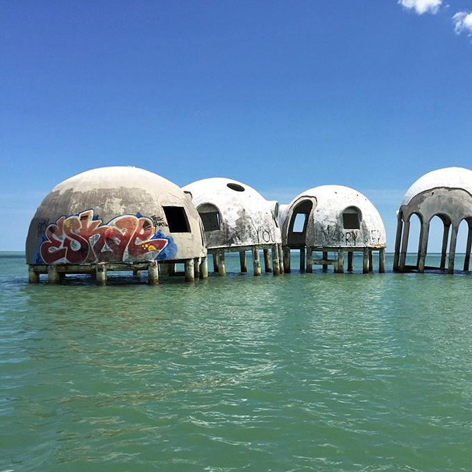 Urban art meets marine decay as graffiti artists have occasionally left their mark, adding splashes of color to the weathered concrete hemispheres.