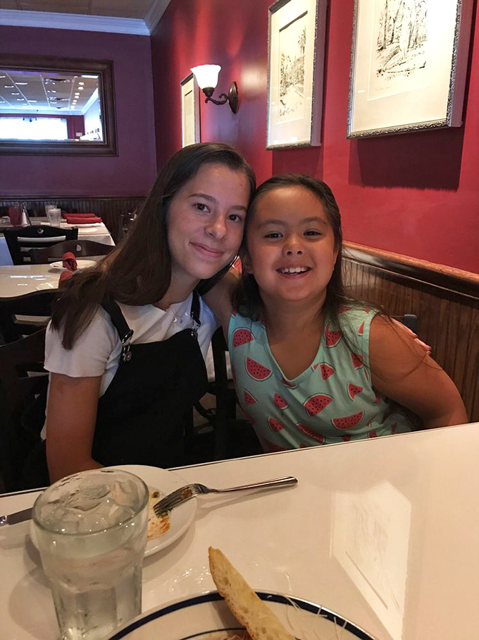 Two happy diners proving that good Italian food is truly a universal language of joy.