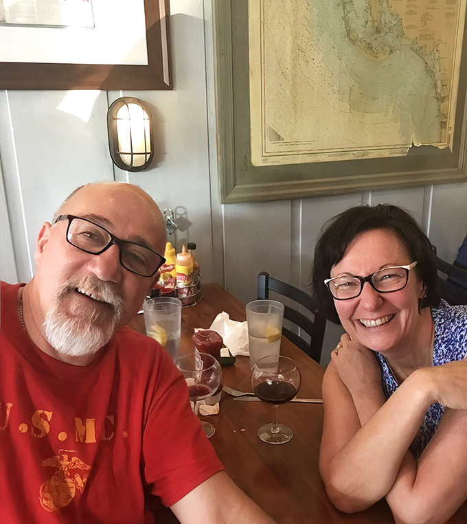 Happy diners raising glasses to great seafood finds. Their expressions say what we're all thinking: "How is this place in Ohio?"