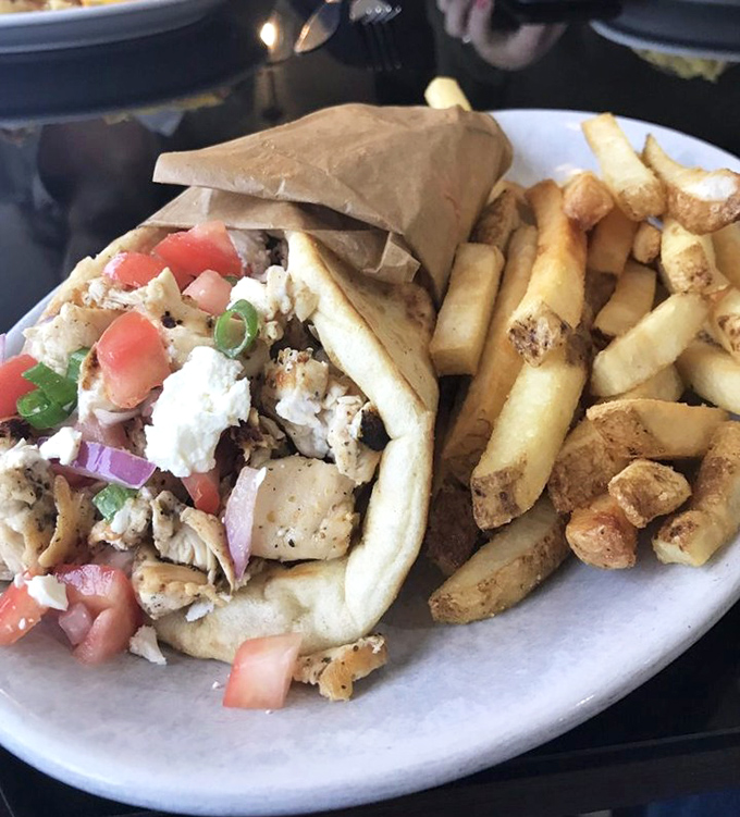 A Greek-inspired gyro that would make Zeus himself descend from Mount Olympus, paired with fries that demand to be savored one by one.