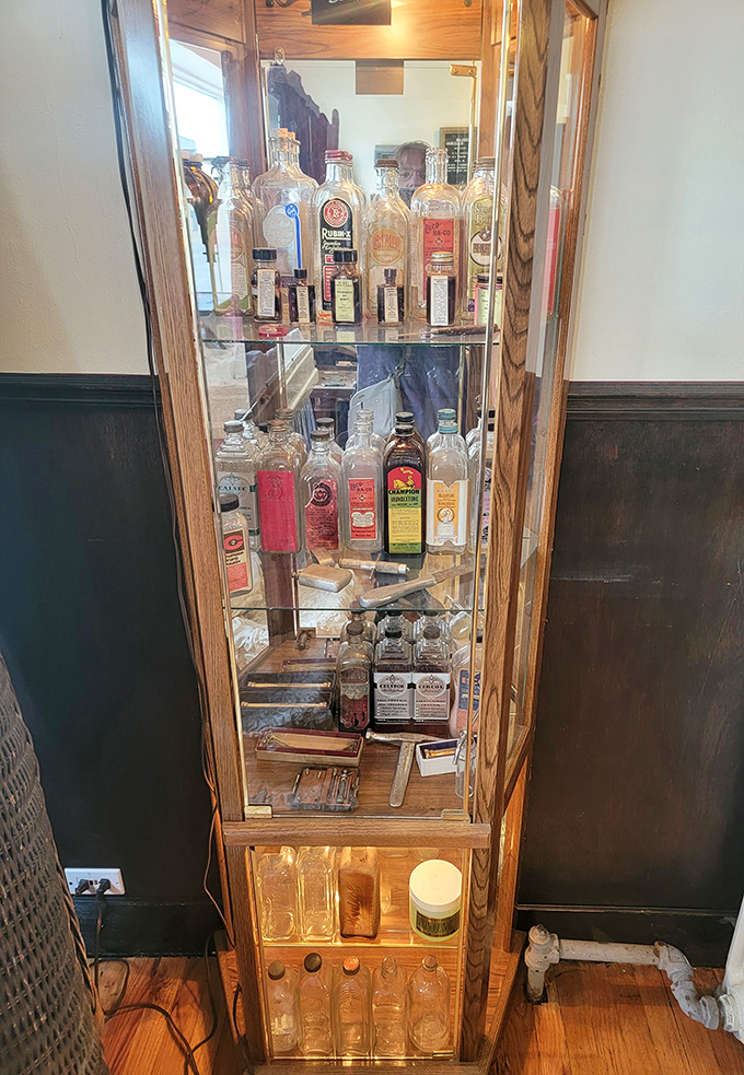 Antique medical and embalming bottles displayed in a vintage cabinet&mdash;remedies and preparations from a less regulated era.