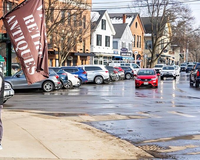 "Reliques" flags announce treasures within, part of Exeter's thriving antique scene where yesterday's heirlooms find tomorrow's appreciative homes.