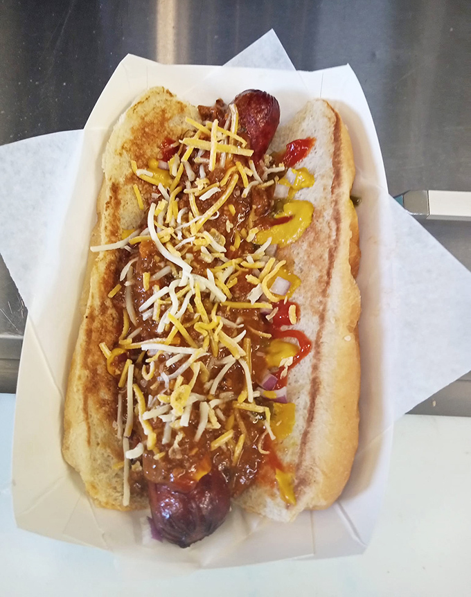The hot dog&mdash;dressed to impress with chili, cheese, and condiments in a harmonious arrangement that makes every bite a flavor party.