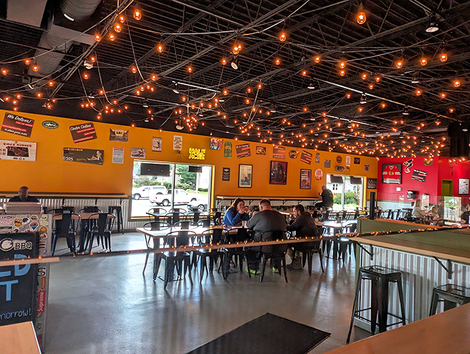 String lights create a festive canopy above diners lost in meat-induced happiness, proving ambiance matters even in the most serious barbecue establishments.