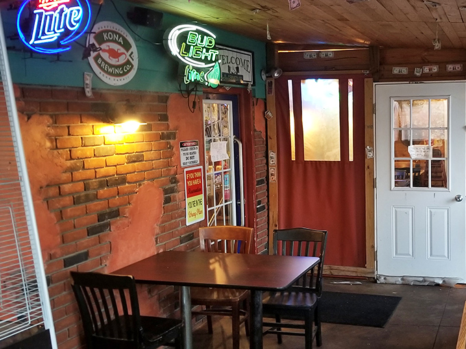 Exposed brick walls, neon beer signs, and simple wooden tables create that rare atmosphere where both first-timers and regulars feel instantly at home.