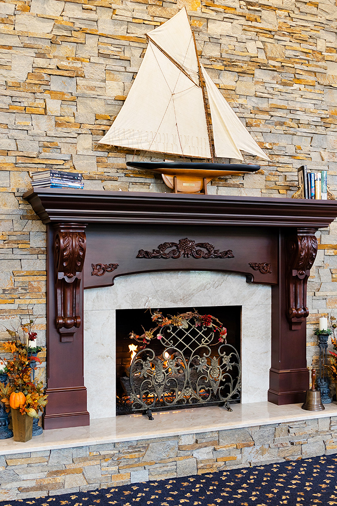 A stone fireplace with nautical accents creates an unexpected maritime-meets-Mediterranean vibe that somehow works perfectly in landlocked Ohio.