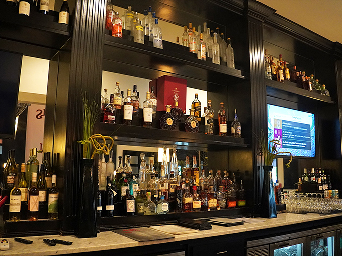 A bar stocked more thoroughly than your retirement portfolio should be, with bottles promising adventures from around the world. 