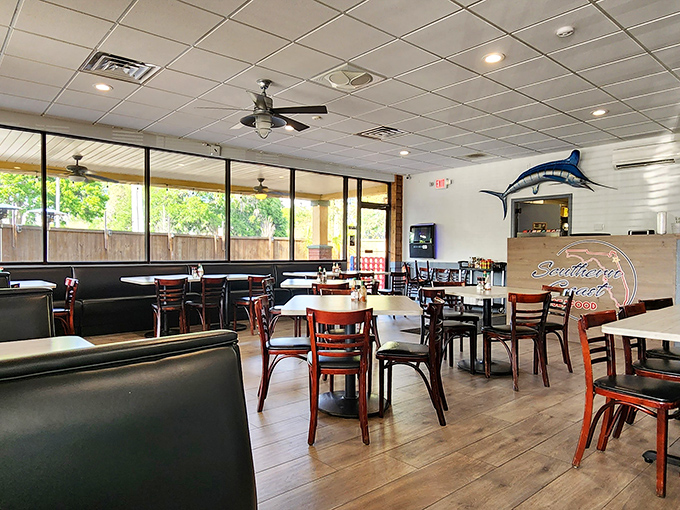 Light floods through large windows, illuminating a dining room where nautical meets comfortable. That marlin watches approvingly over every plate.