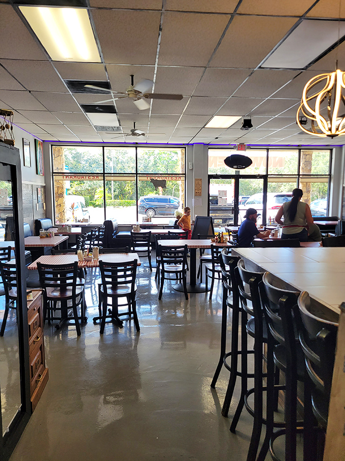 Another angle of JoJo's welcoming interior&mdash;where the counter seating lets you watch breakfast magic happen and windows let in that famous Florida sunshine.