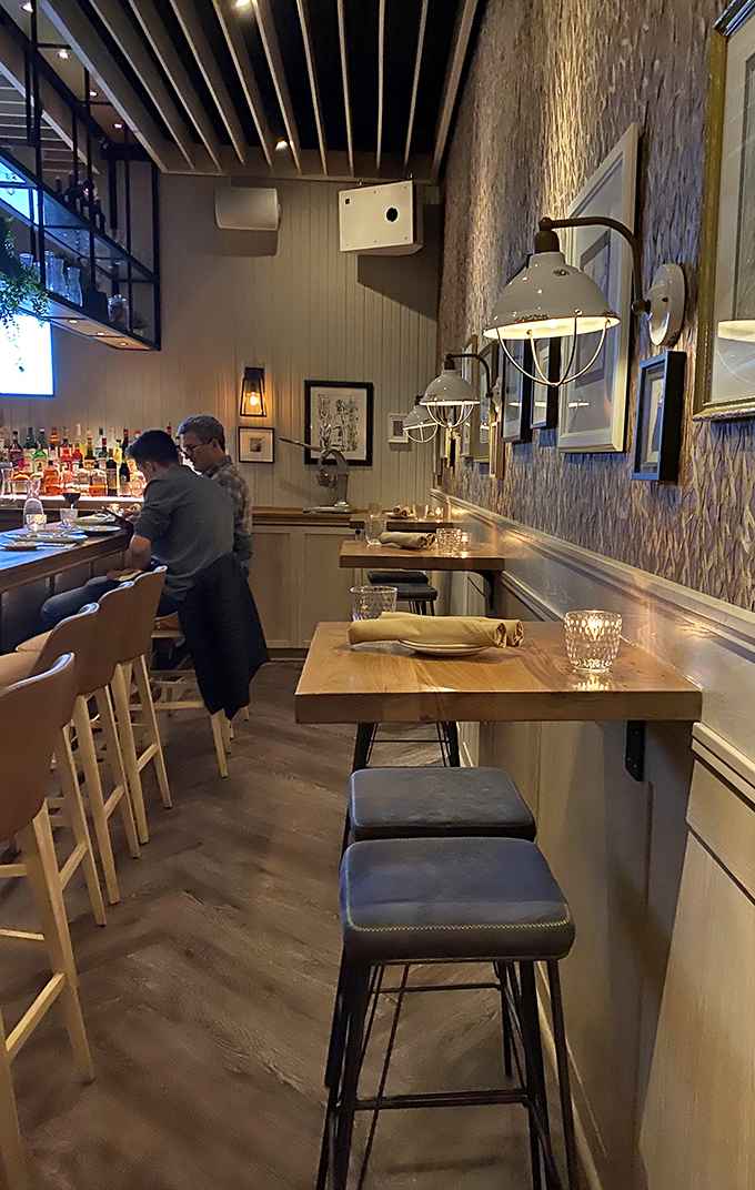 The bar area's warm lighting and thoughtful design invite you to linger over one more glass of whatever makes you happy.