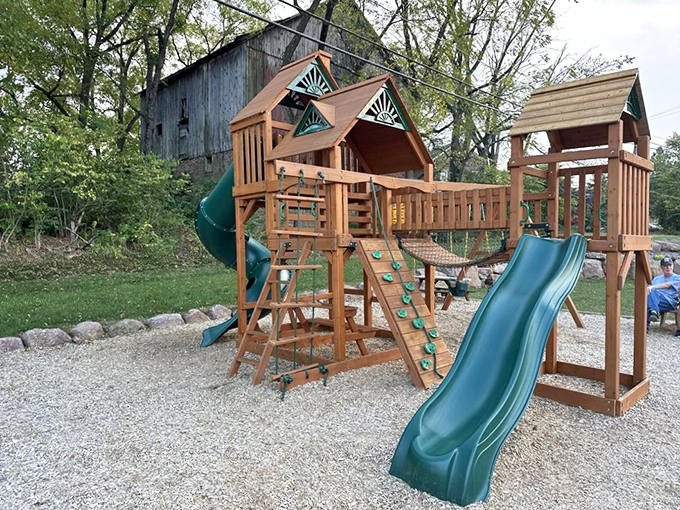 A playground where kids burn off barbecue energy while parents contemplate a second helping. Strategic planning at its finest.