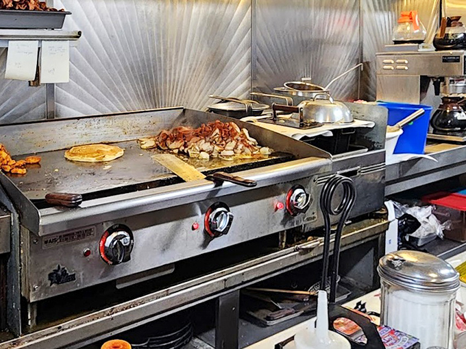 The command center where breakfast dreams become reality – a well-worn griddle that's seen more action than John Wayne.