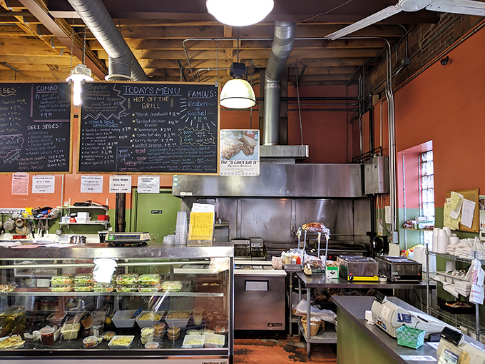 The open kitchen layout reveals the organized chaos where deli dreams come true &ndash; nothing fancy, just solid culinary craftsmanship.