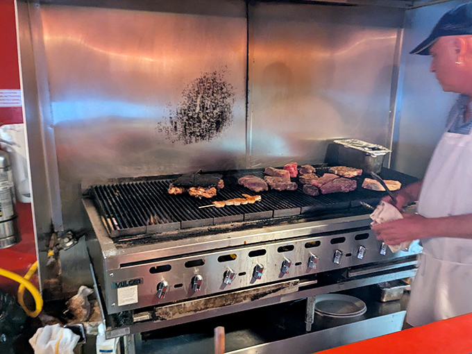 The grill master at work, orchestrating a symphony of sizzles and smoke that will soon become the highlight of someone's week.