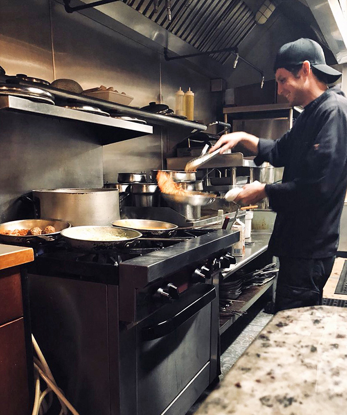 A chef in his natural habitat, conducting a delicious orchestra of sizzling pans. This is the sound that happiness makes.