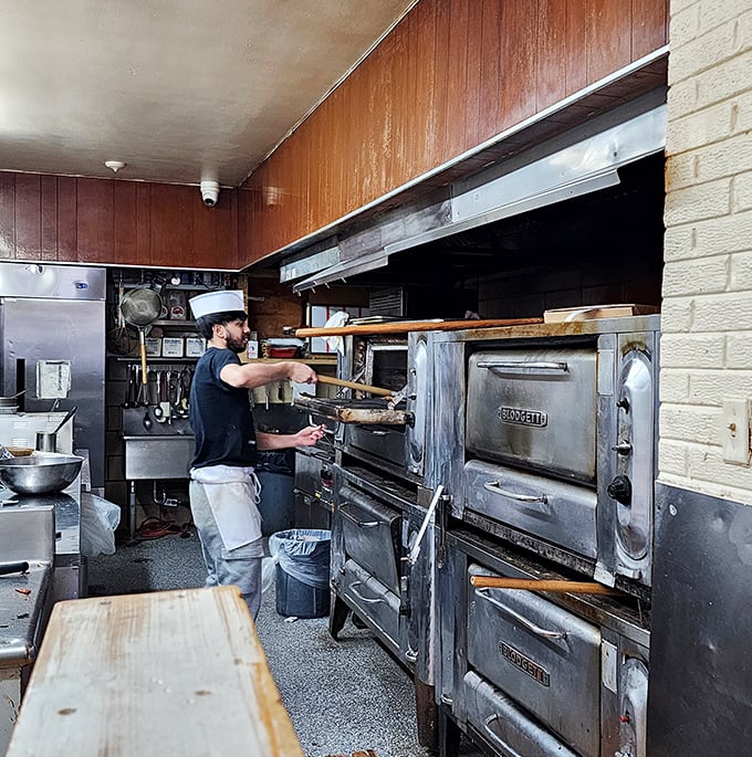 No fancy wood-fired ovens here – just decades-old workhorses that know exactly how to transform dough into magic.