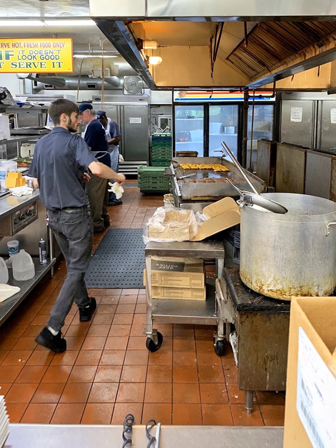 Behind the scenes, where the magic happens on well-seasoned grills that have seen more action than most battlefield memorials.