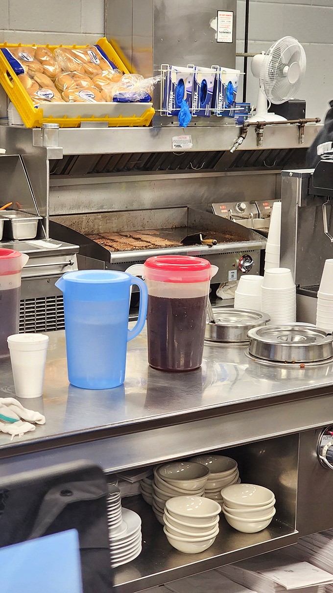 A glimpse into the kitchen where the magic happens. That flat-top grill has probably cooked enough burgers to reach the moon and back.