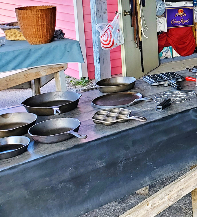 Cast iron cookware that's seen decades of family meals lines this table. These seasoned pans hold more stories than a library.