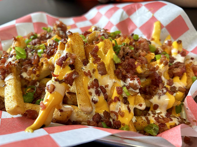 These aren't just loaded fries&mdash;they're a commitment. Cheese, bacon, and green onions creating a fork-required masterpiece that demands your full attention.