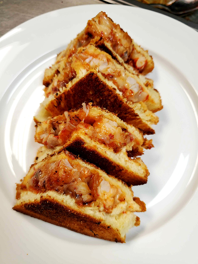 This isn't just a grilled cheese, it's a lobster's grand entrance into sandwich royalty. Each triangular slice promises a perfect meat-to-cheese ratio.