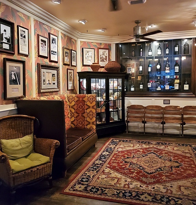 The lounge area feels like the cozy library of a well-traveled sea captain - vintage photos, patterned wallpaper, and comfortable seating inviting lingering conversations.
