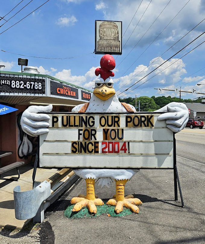 "Pulling our pork for you since 2014!" declares the cheerful chicken mascot. This roadside ambassador has witnessed thousands of sauce-stained smiles over the years.