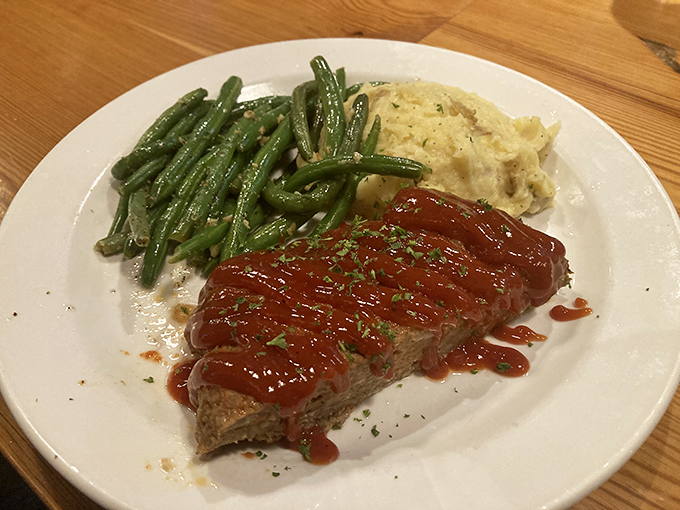 Meatloaf that doesn't apologize for being meatloaf. The green beans and mashed potatoes are playing perfect supporting roles.