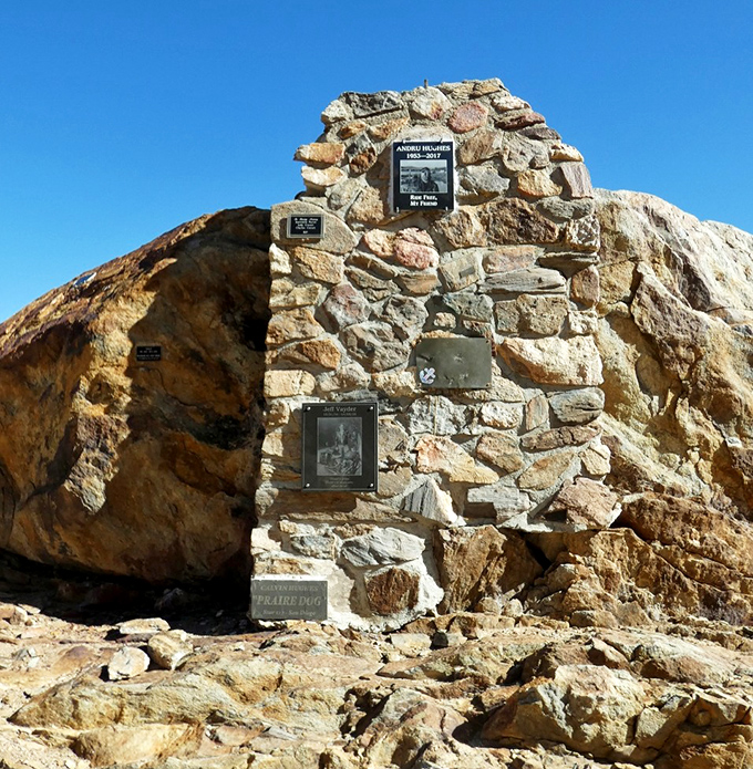 History etched in stone. This memorial point reminds us that even in vast wilderness, human stories find their place among the ancient rocks.